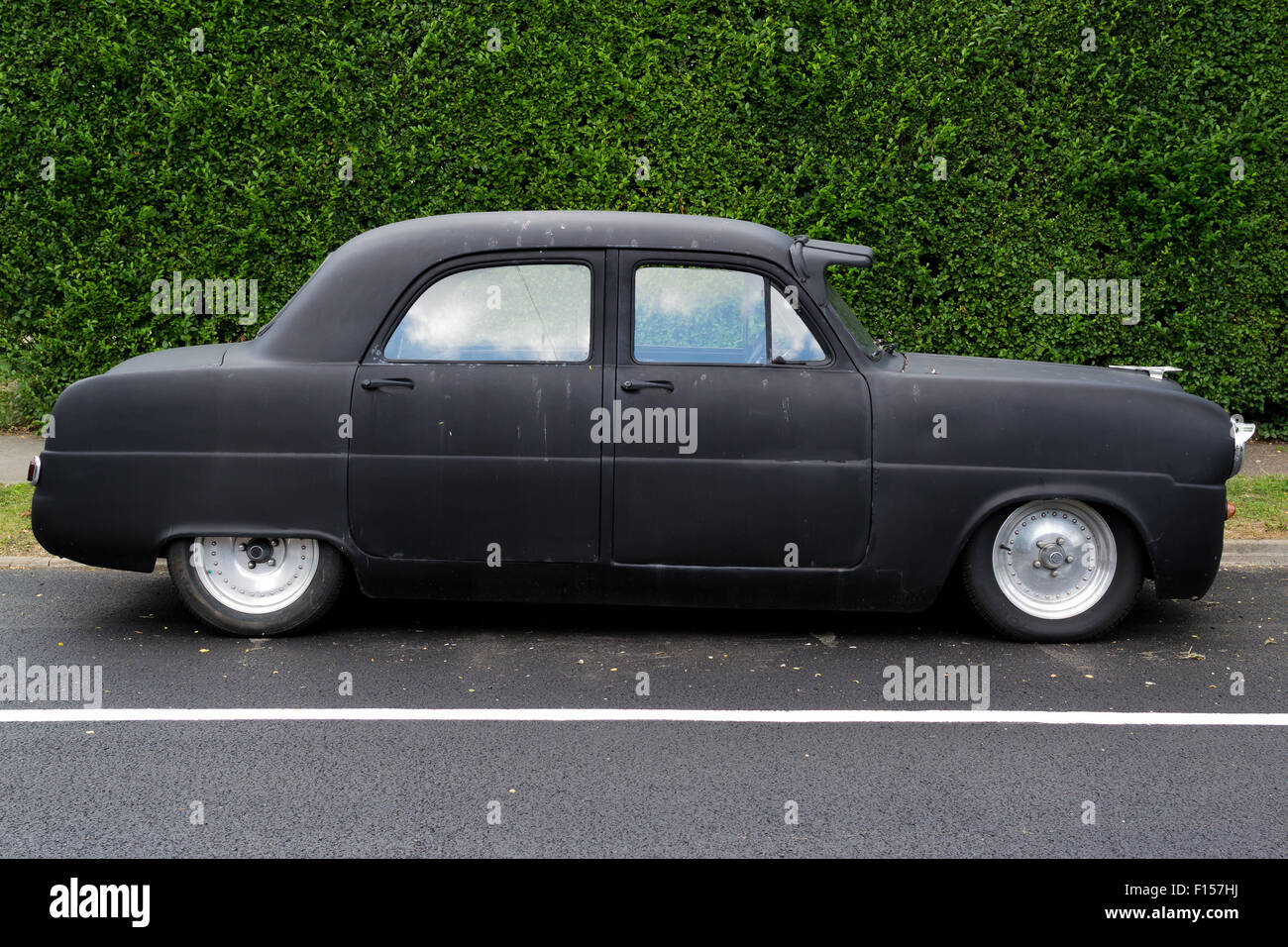 Customized black car with gun metal black paint stationary on a tarmac ...
