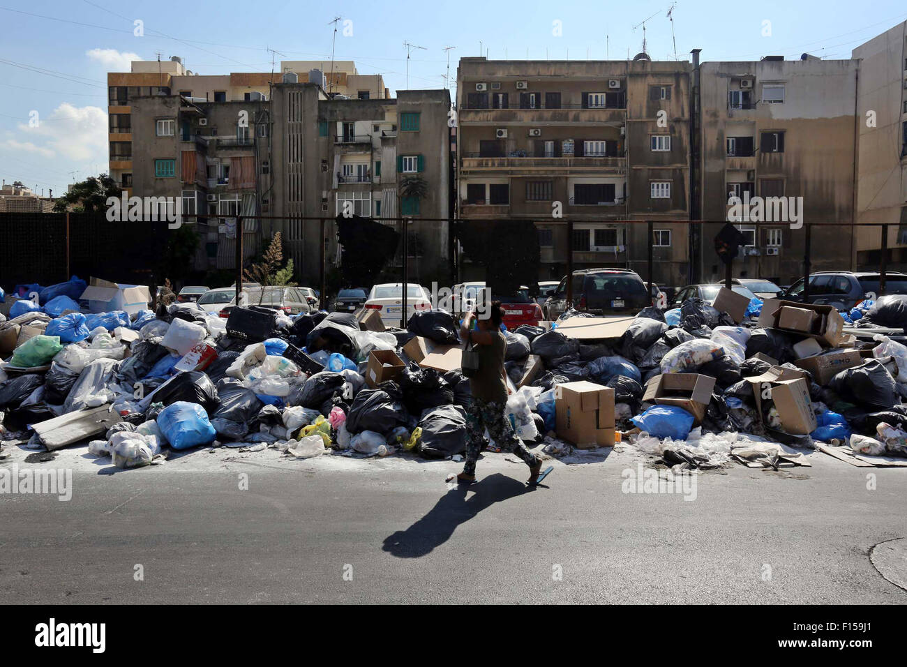 Beirut, Beirut, Lebanon. 27th Aug, 2015. A woman walks past piles of ...