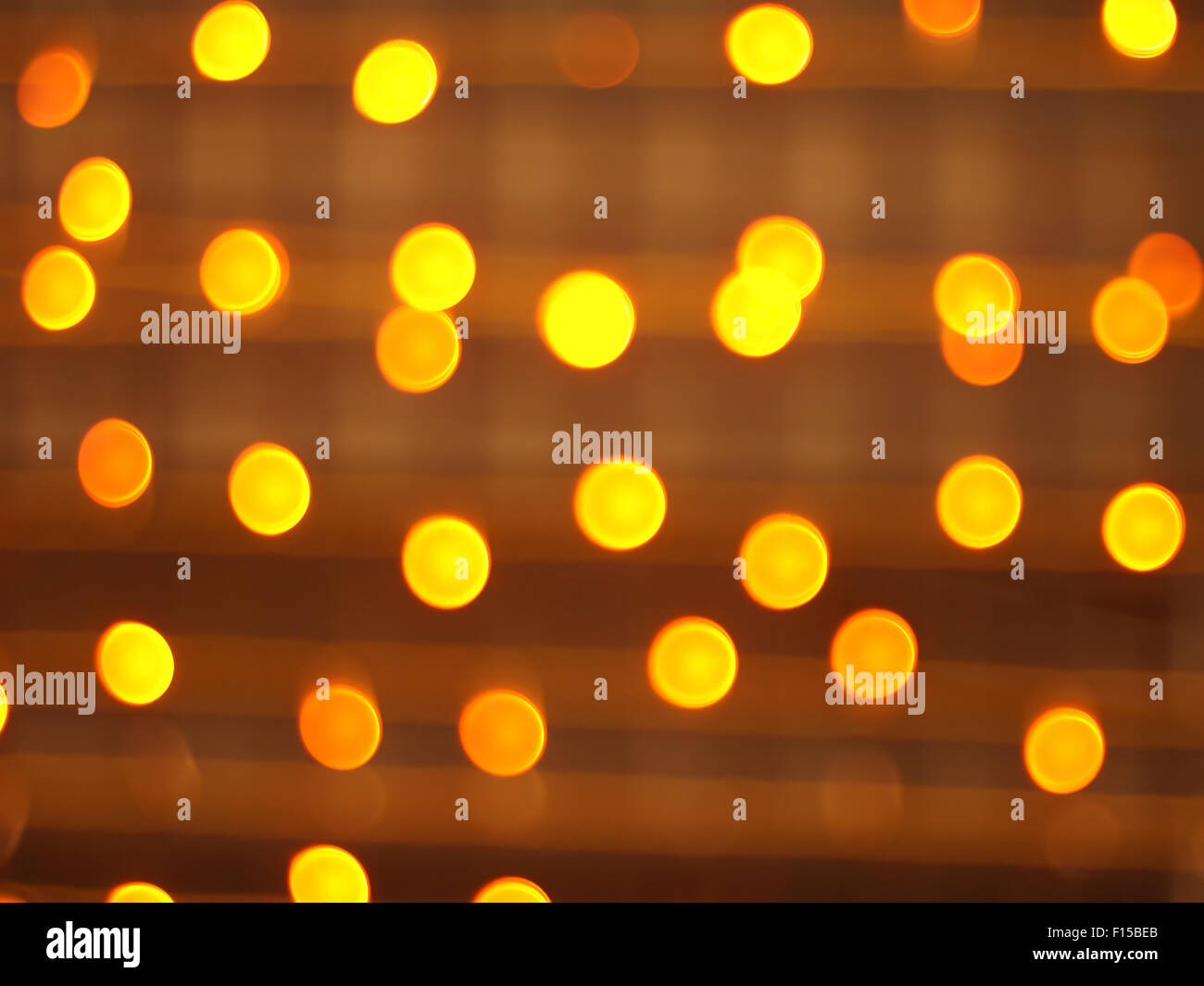 Defocused and blur image of yellow round light bulb on the whole frame ...