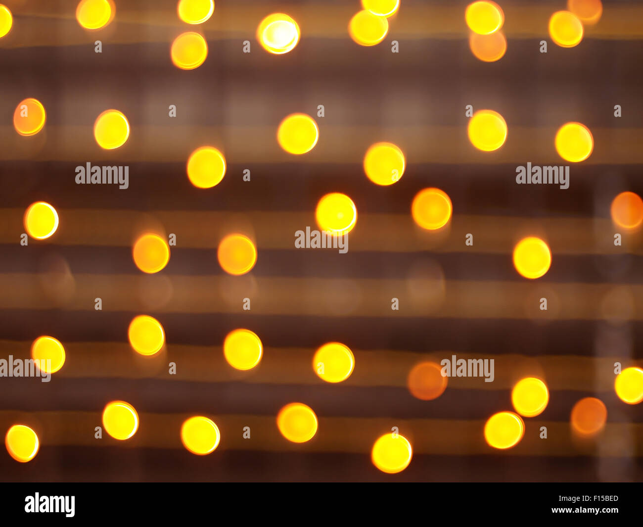 Defocused and blur image of yellow round light bulb on the whole frame ...
