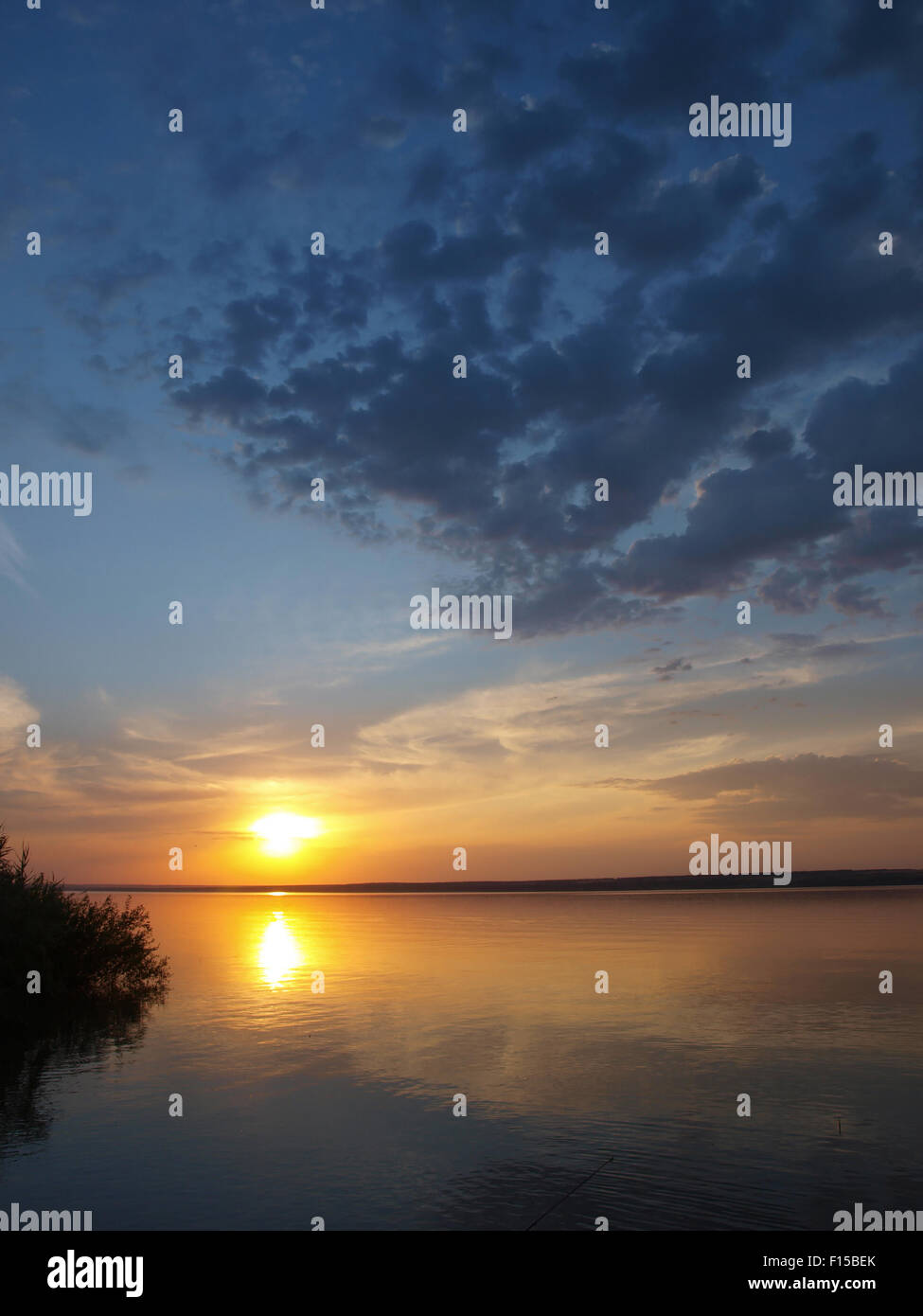 Summer sundown on lake closeup Stock Photo - Alamy