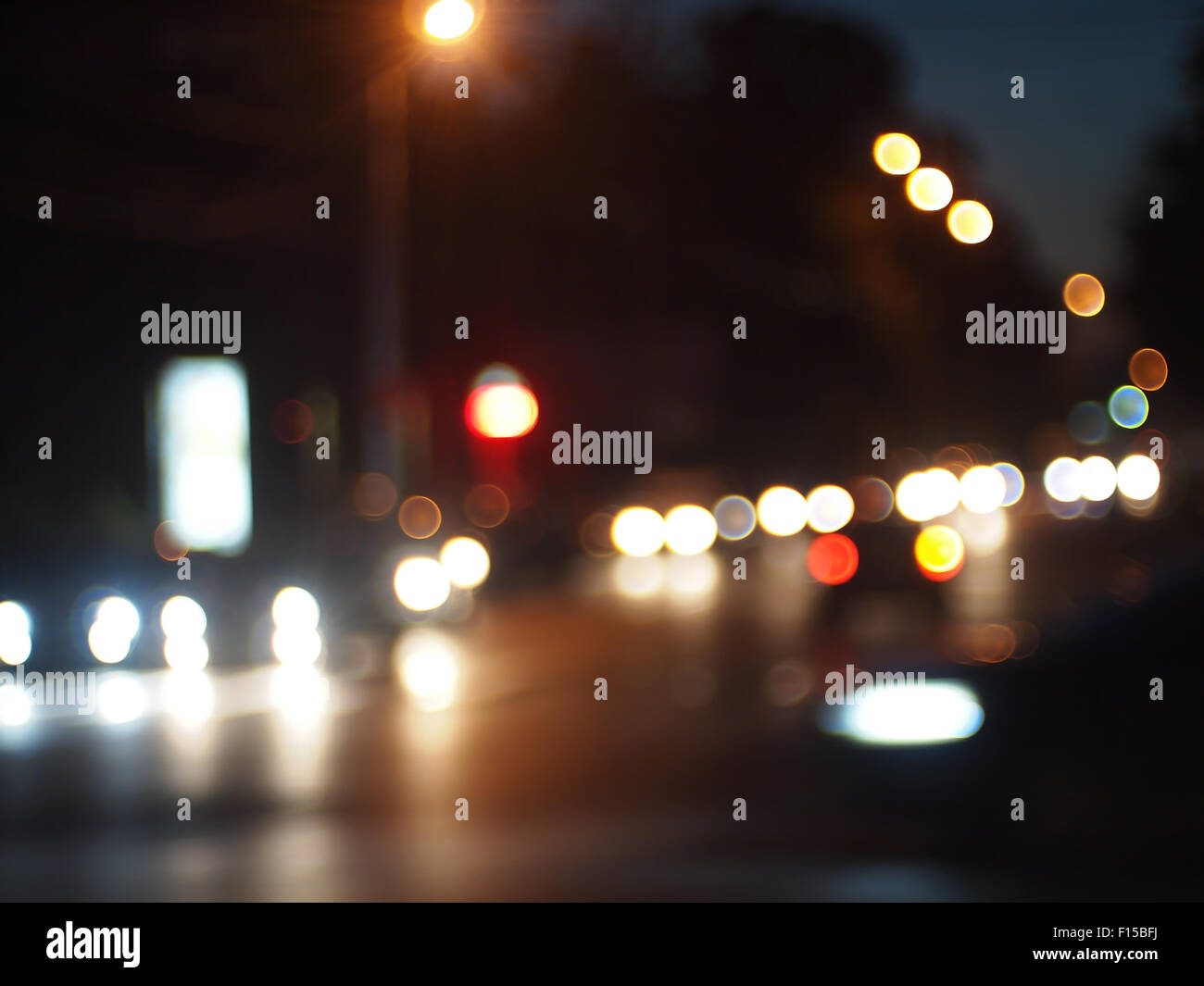 Blurred out of focus lights from cars, traffic lights and street lights ...