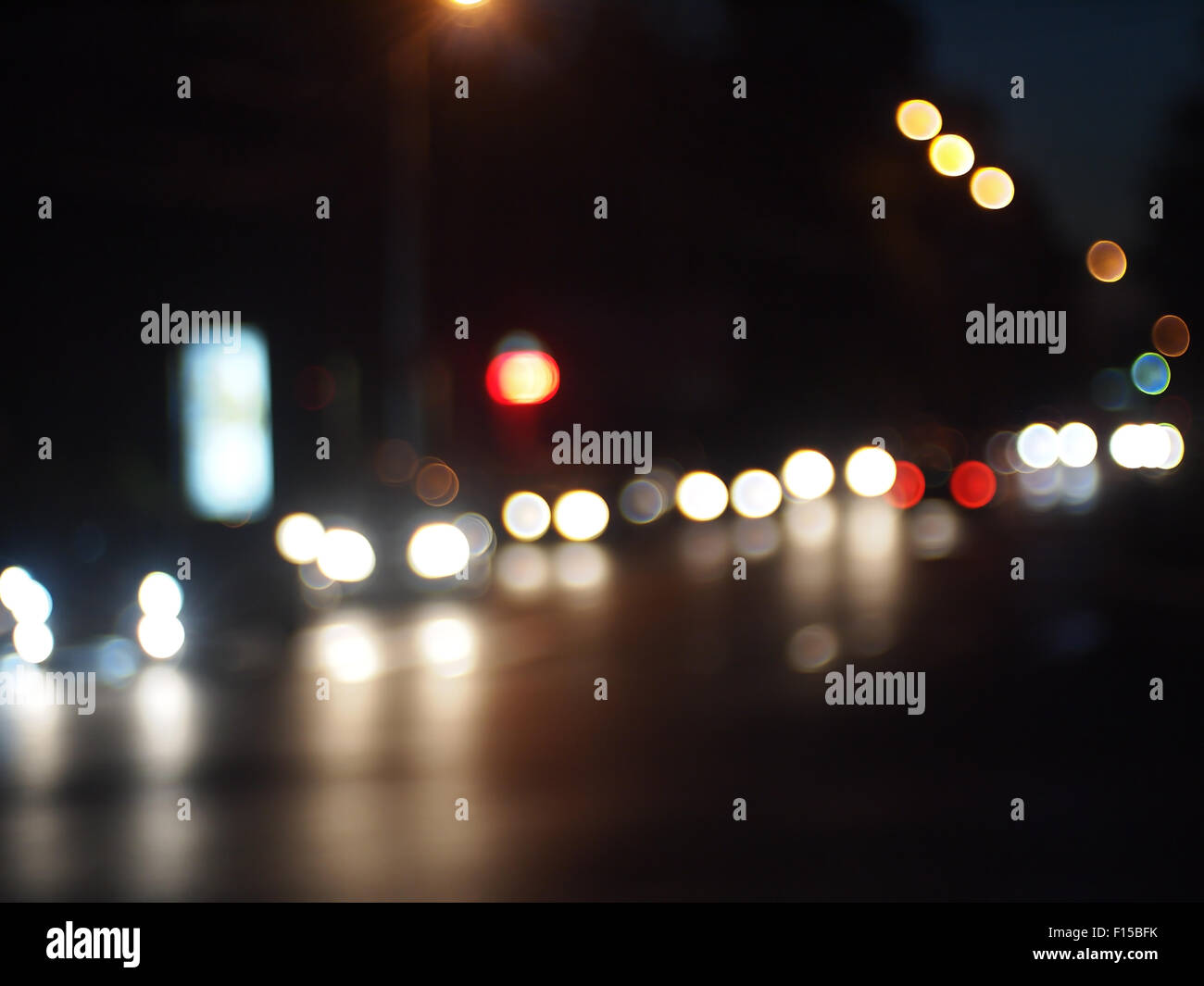 Night scene - defocused car, the lights from the headlights and tail ...