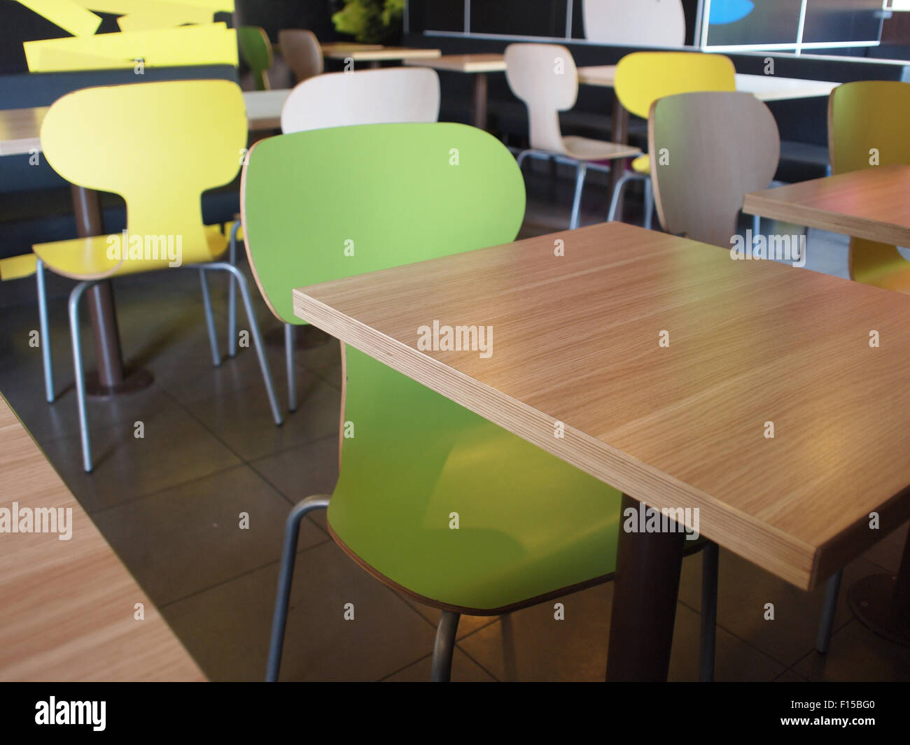 Wooden tables and chairs with furiture in a fast food restaurant ...