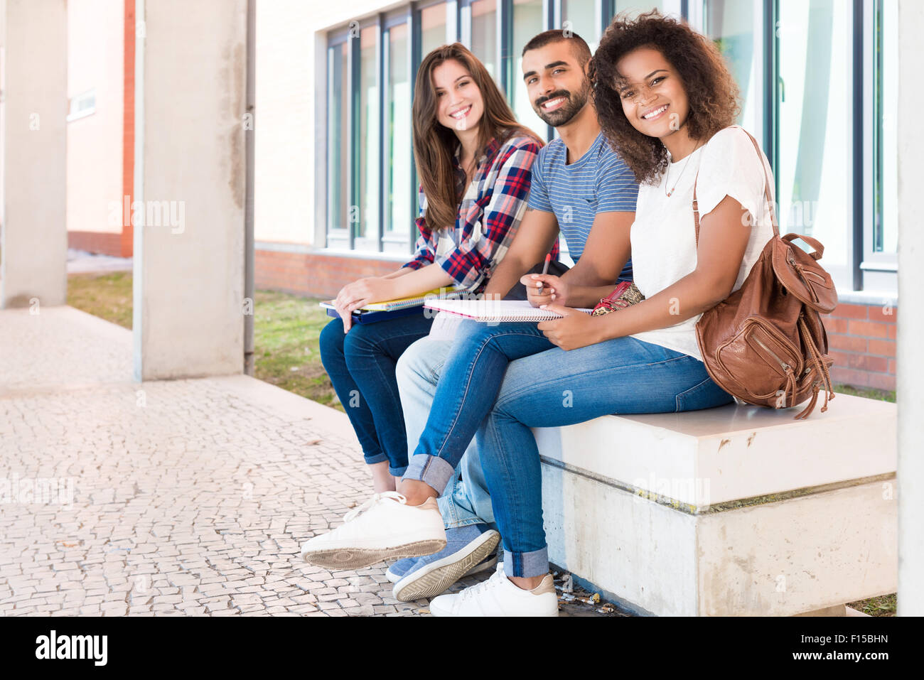 Students sharing notes in the university campus Stock Photo - Alamy