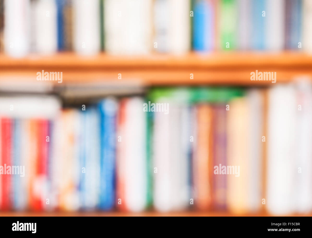 blurred background from many books on bookshelf Stock Photo - Alamy