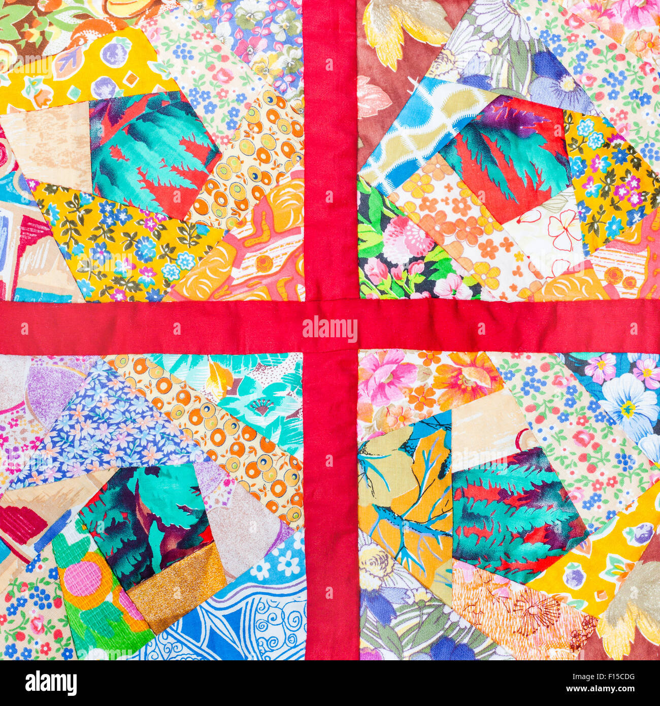 four details of hand made patchwork quilt framed in red cloth Stock ...