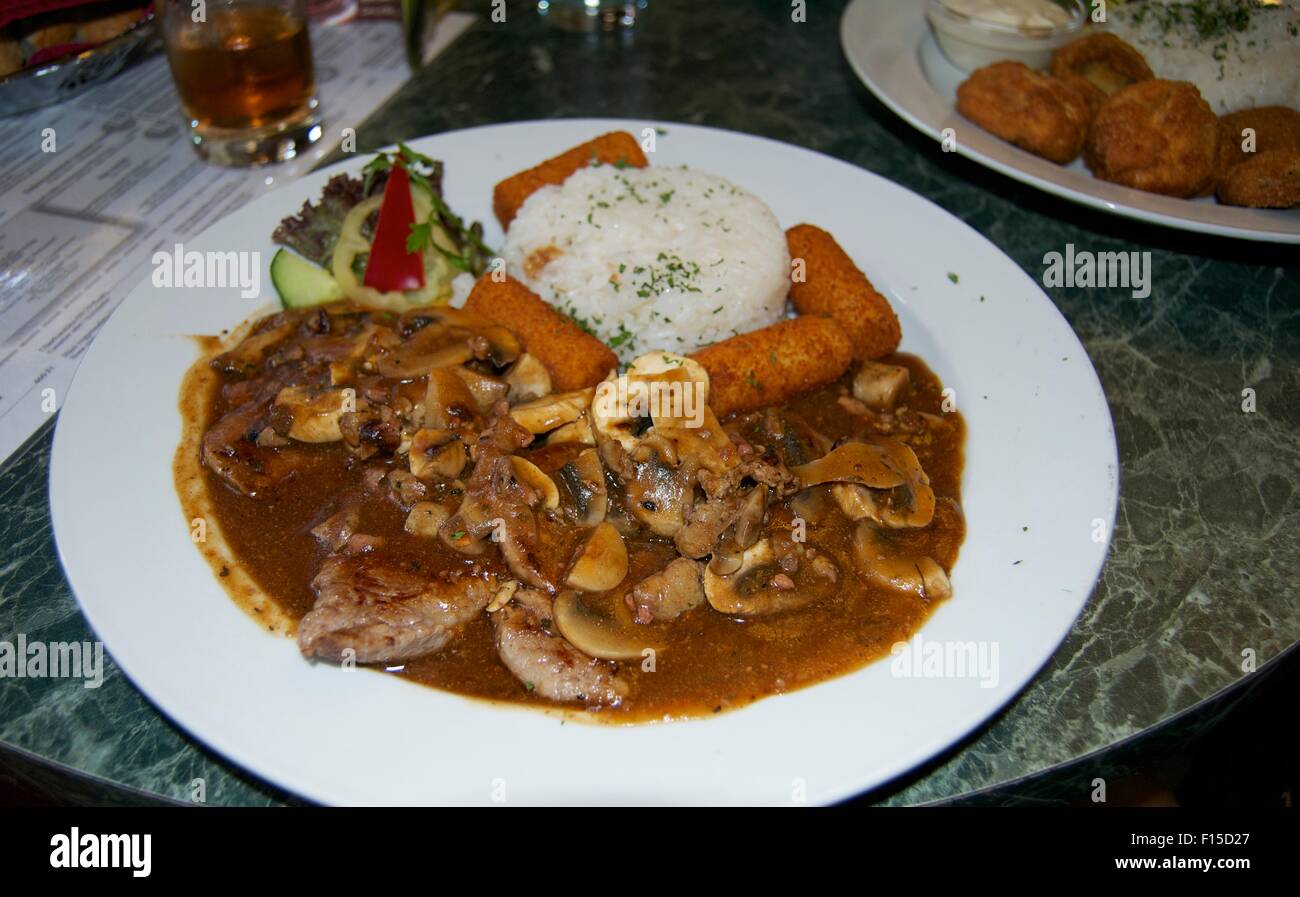 Hungarian cuisine mushrooms rice pork medallions Stock Photo - Alamy