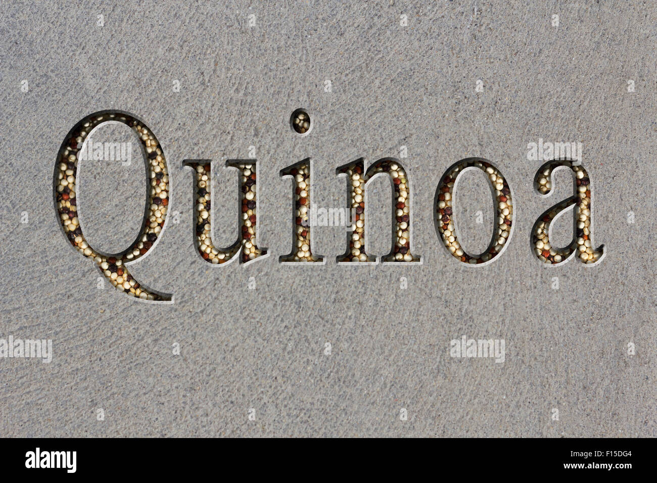 Text engraving word quinoa with quinoa grains filling up the engraving ...