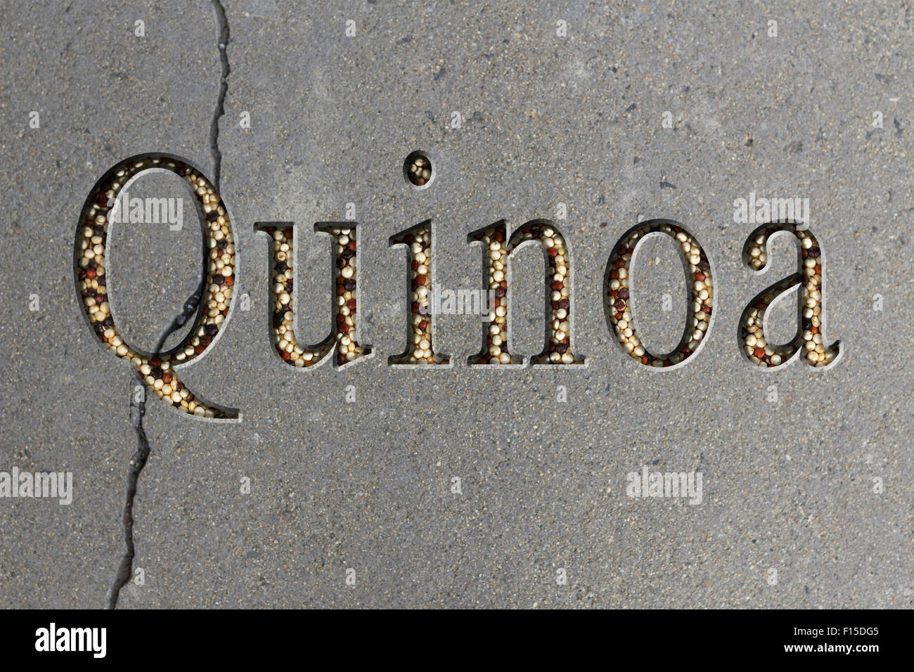 Text engraving word quinoa with quinoa grains filling up the engraving ...