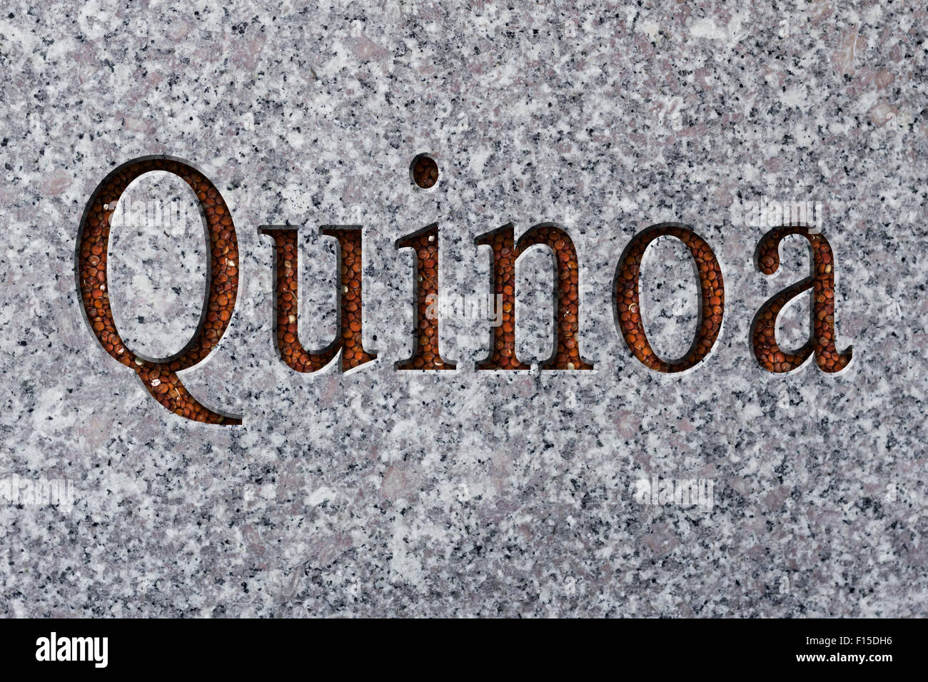 Text engraving word quinoa with quinoa grains filling up the engraving ...