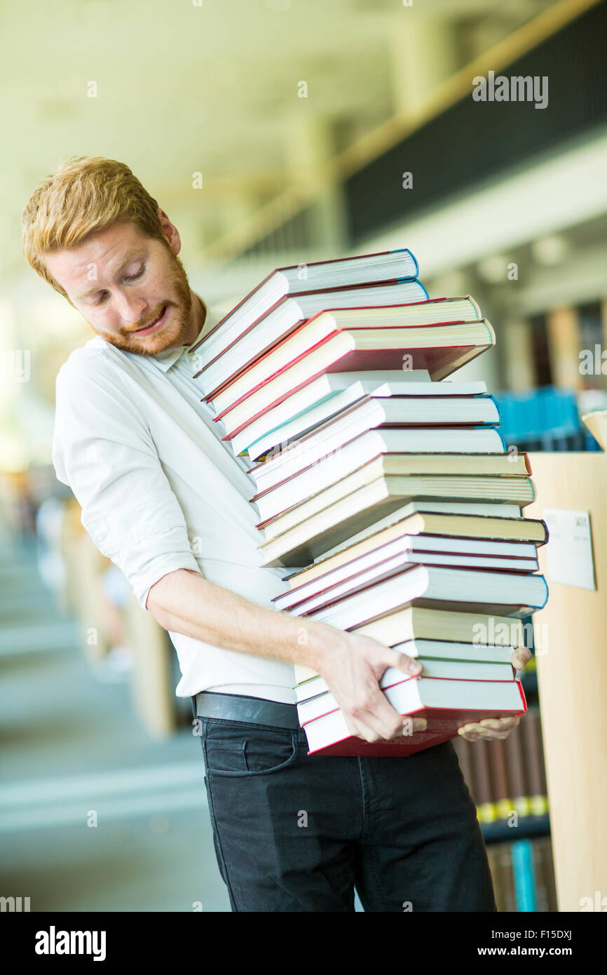 Young man in the library Stock Photo - Alamy