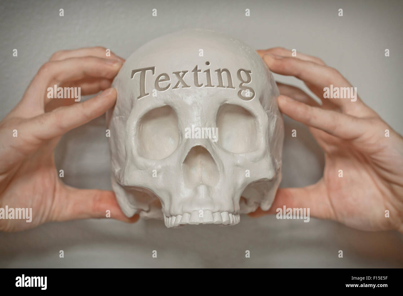 Engraved word texting on skull spell out cause of death Stock Photo - Alamy