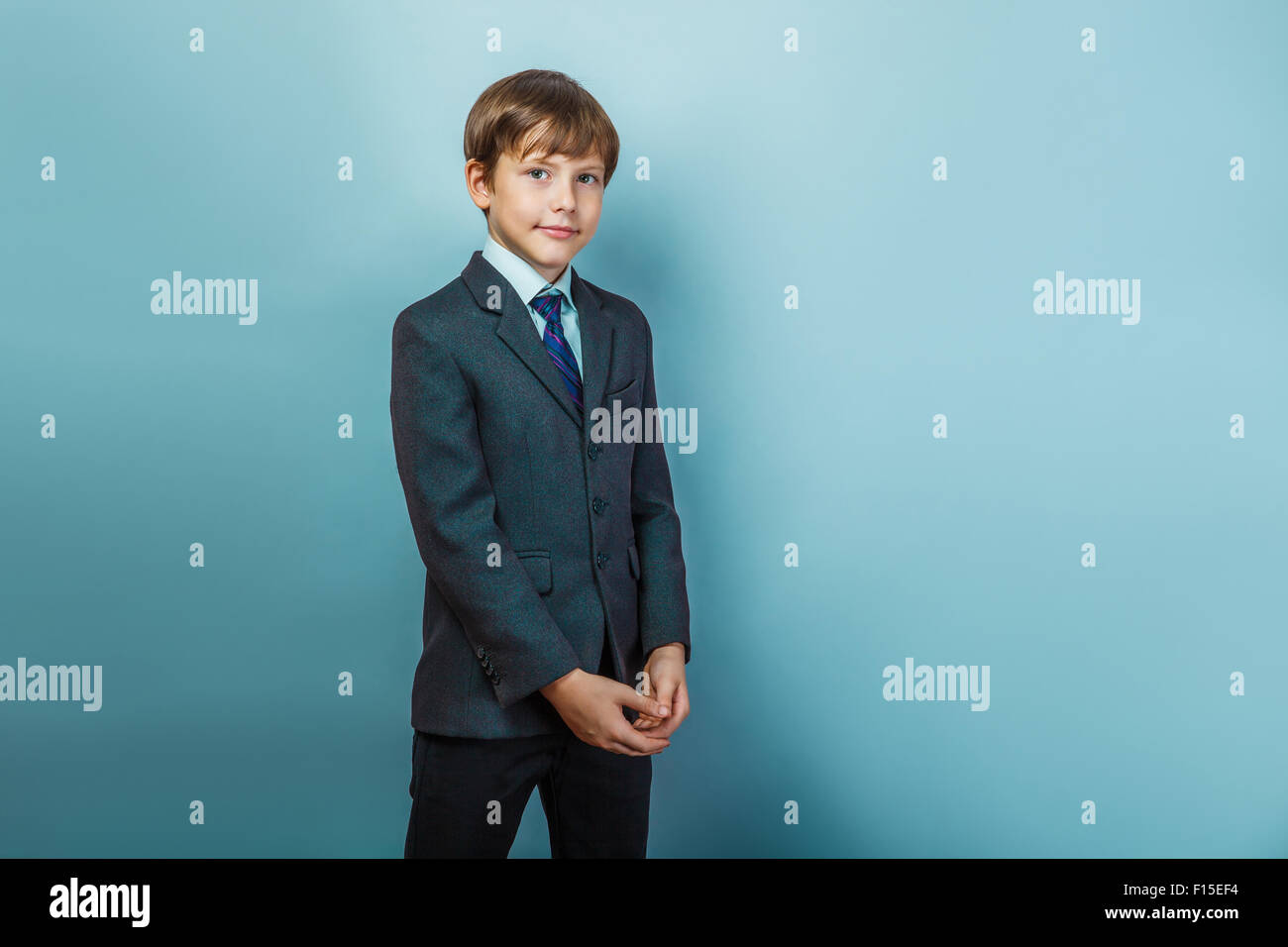 a boy of twelve European appearance in a suit is smiling portrai Stock ...