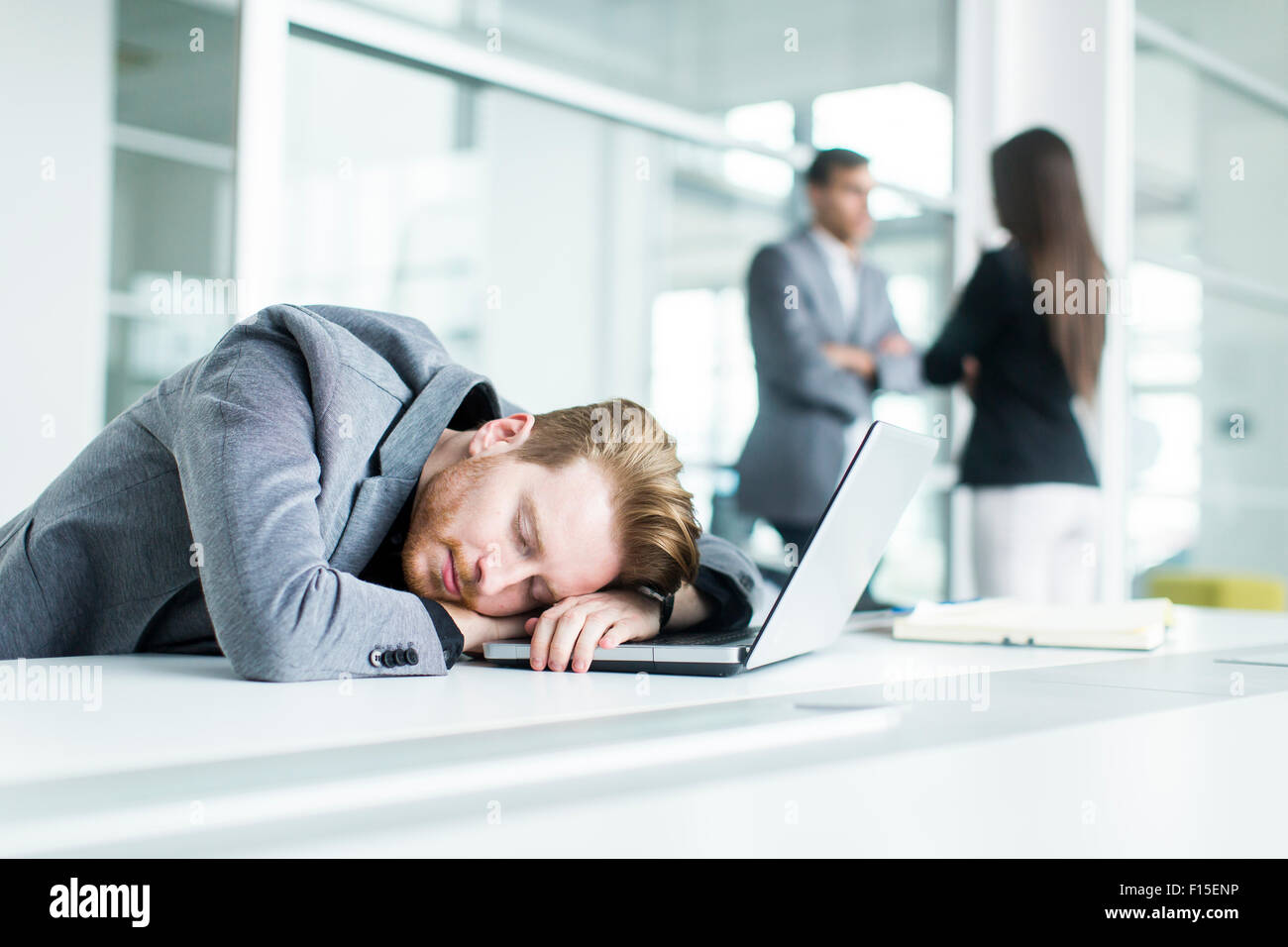 Tired young man sleeping in the office Stock Photo - Alamy