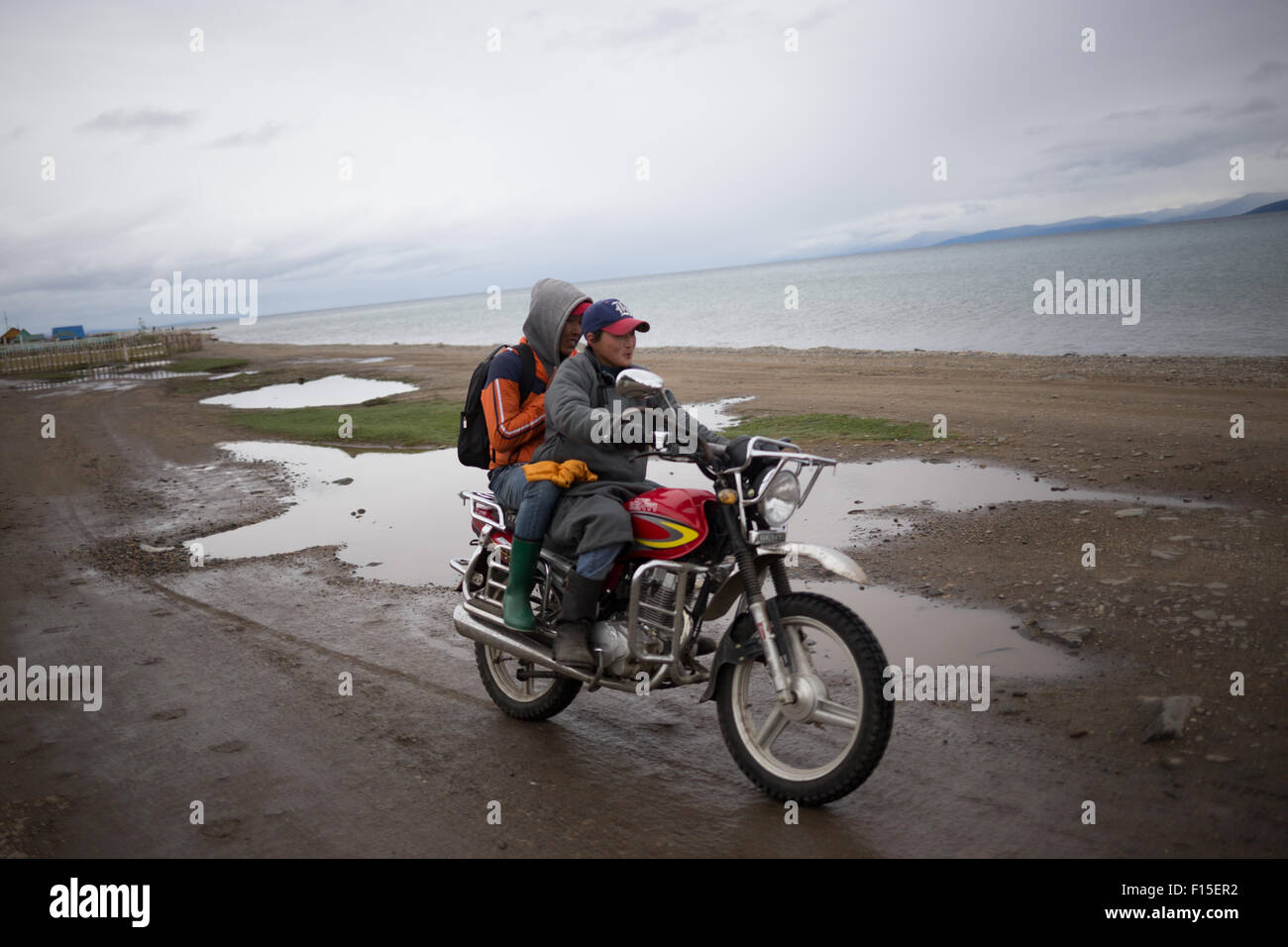 Mongolians on a motorcycle in Northern Mongolia Stock Photo - Alamy