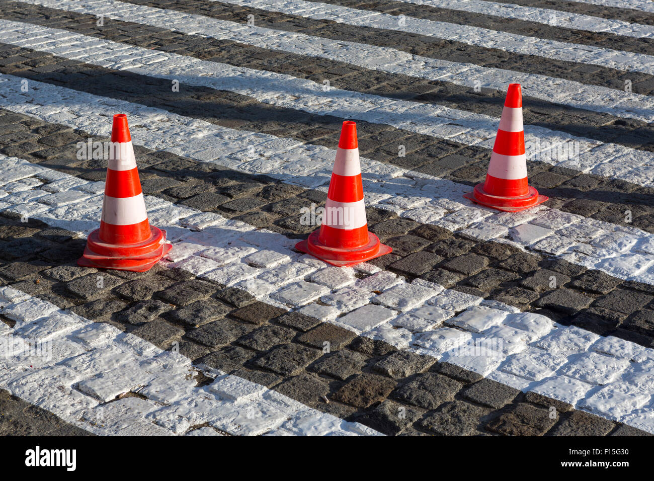 Three taffic cones on a zebra crossing Stock Photo - Alamy