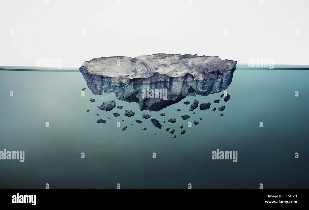 Crumbling rock floating in clear blue water Stock Photo - Alamy