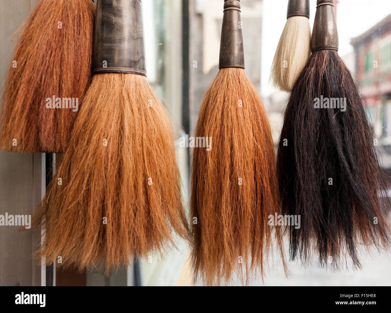 Calligraphy brushes hanging outside an artist supply store in a Beijing ...