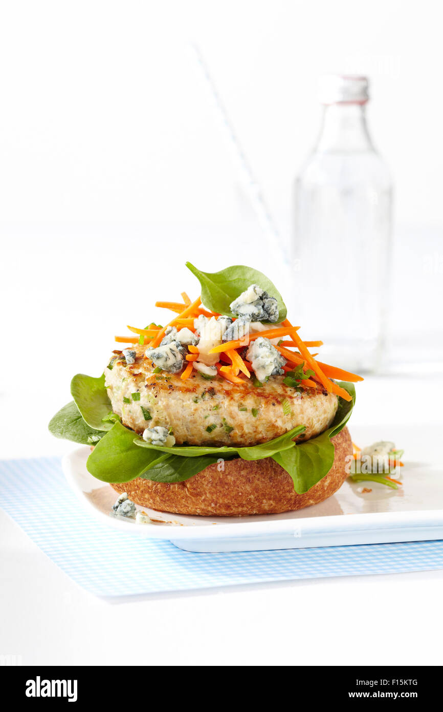 Open-faced, buffalo chicken burger with blue cheese on plate, studio ...