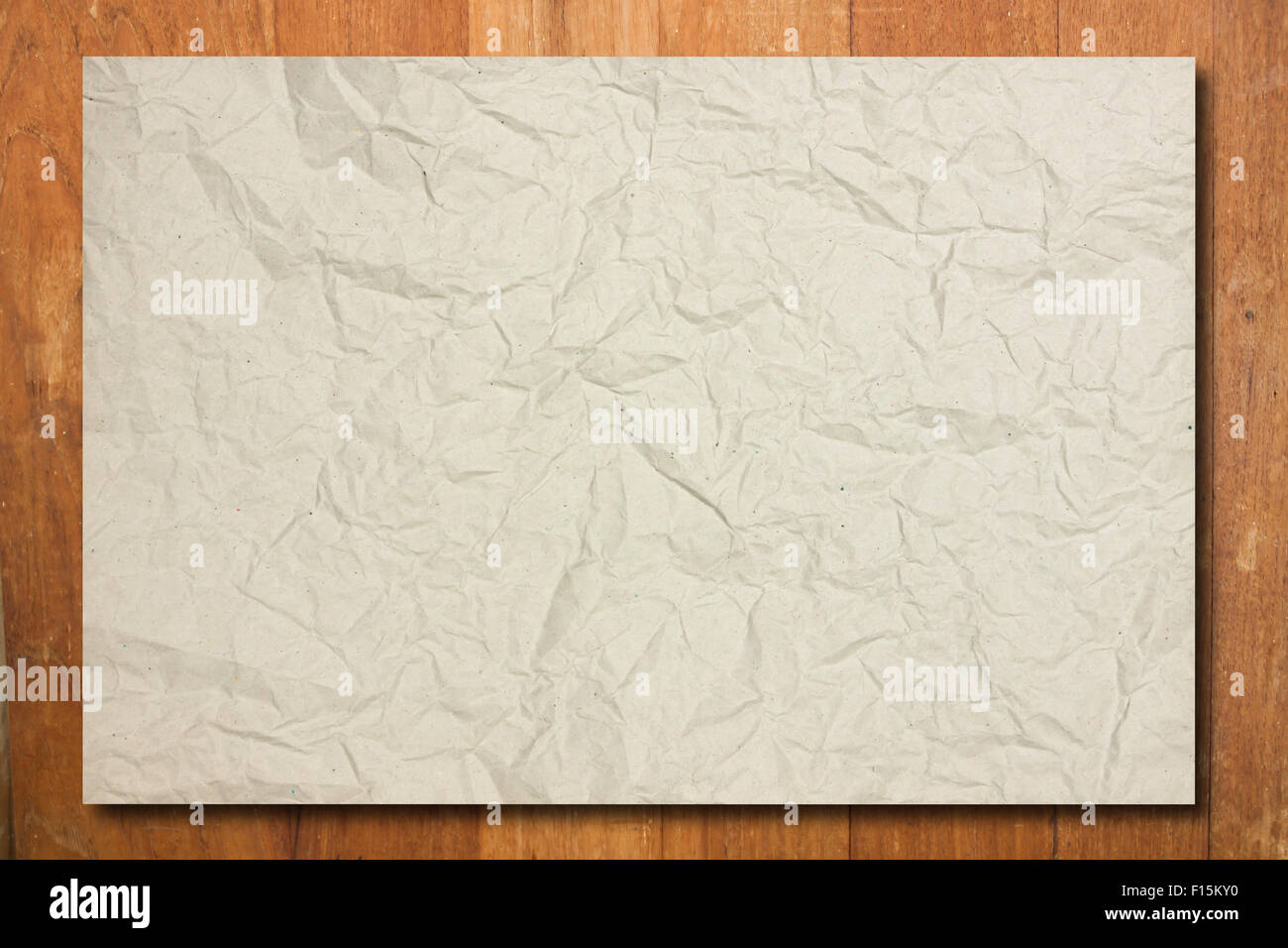 Crumpled paper on wood wall Stock Photo - Alamy