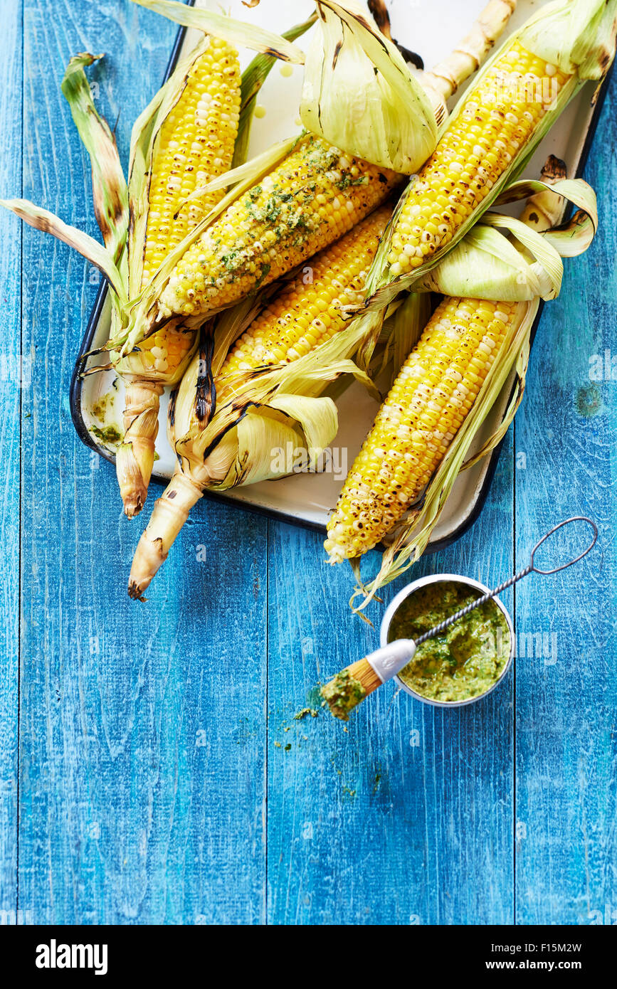 Grilled, corn on the cob with basting brush and herb butter, studio ...