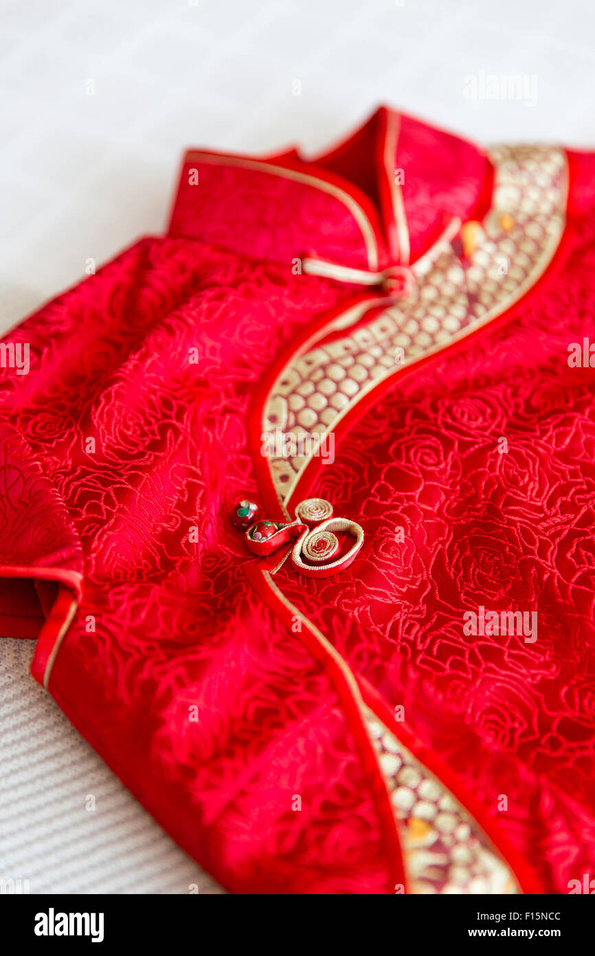 Close-up of a red, cheongsam dress, studio shot on white background ...