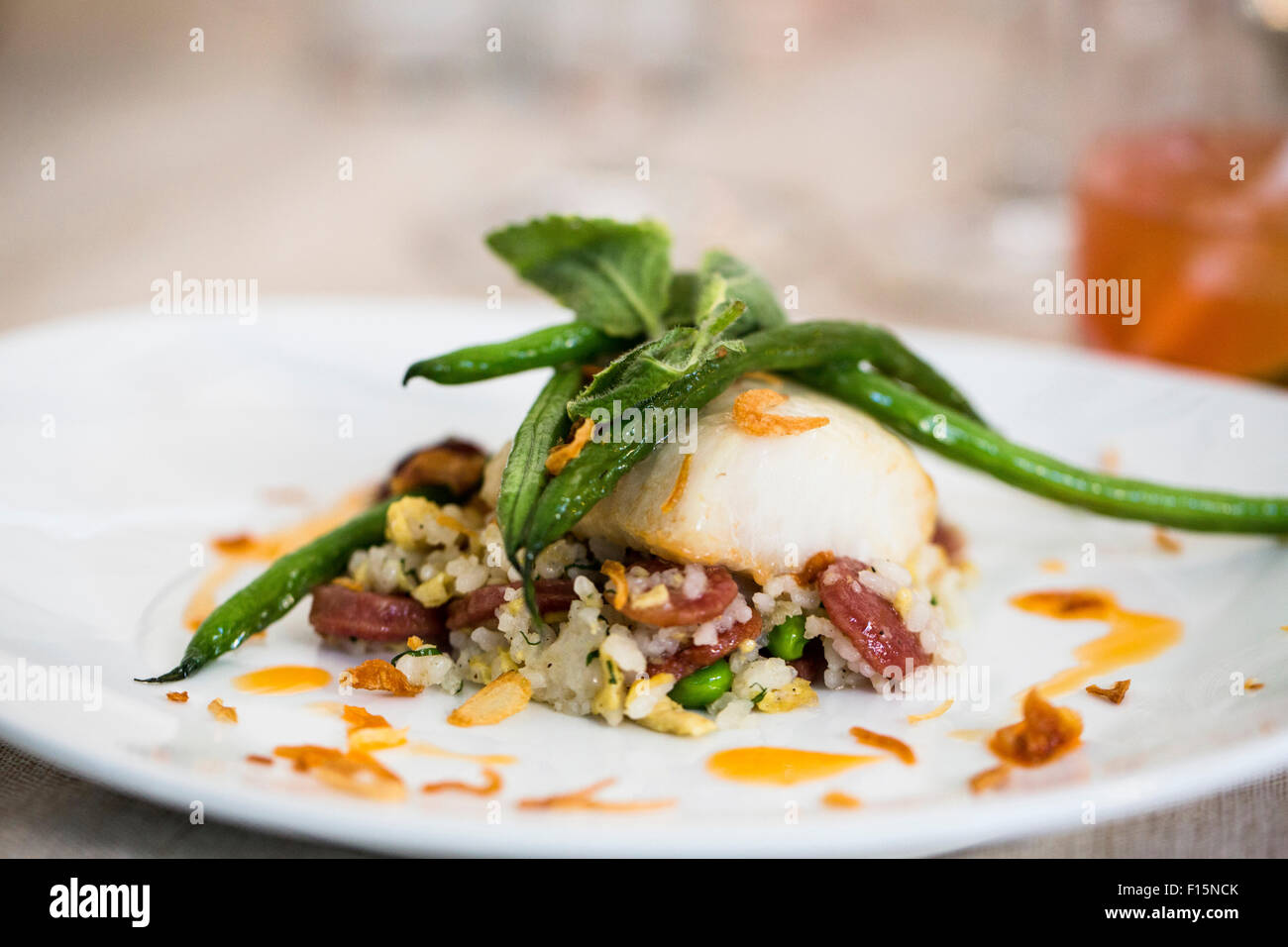 Close-up of black cod fish filet with Chinese sausage and rice side ...