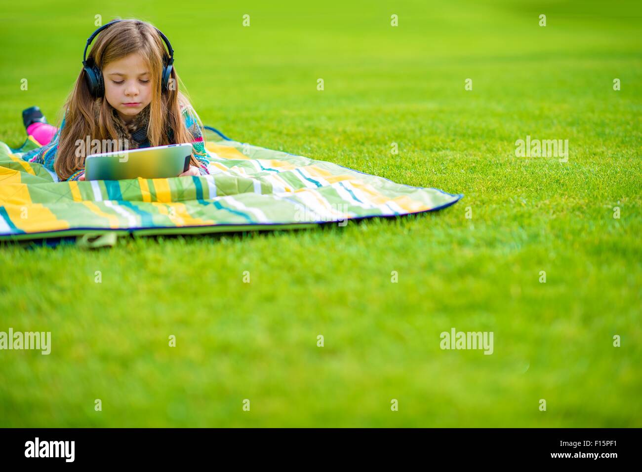 Girl Learning Language While Laying on the Park Green Field. Caucasian ...