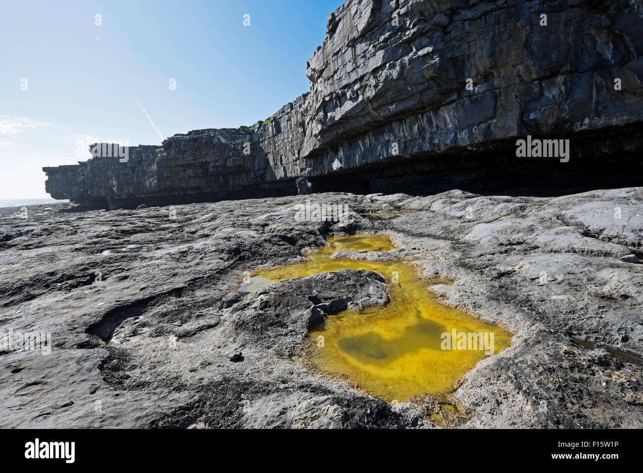 Coastal cliffs with tidal pool on rocky shoreline, Aran Islands ...