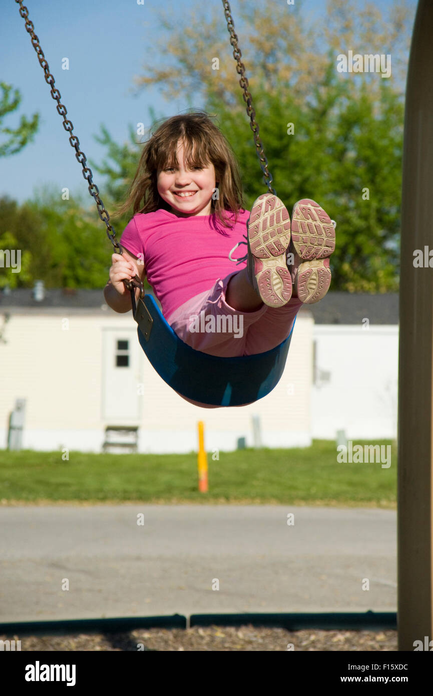 Young girl on swingset Stock Photo - Alamy