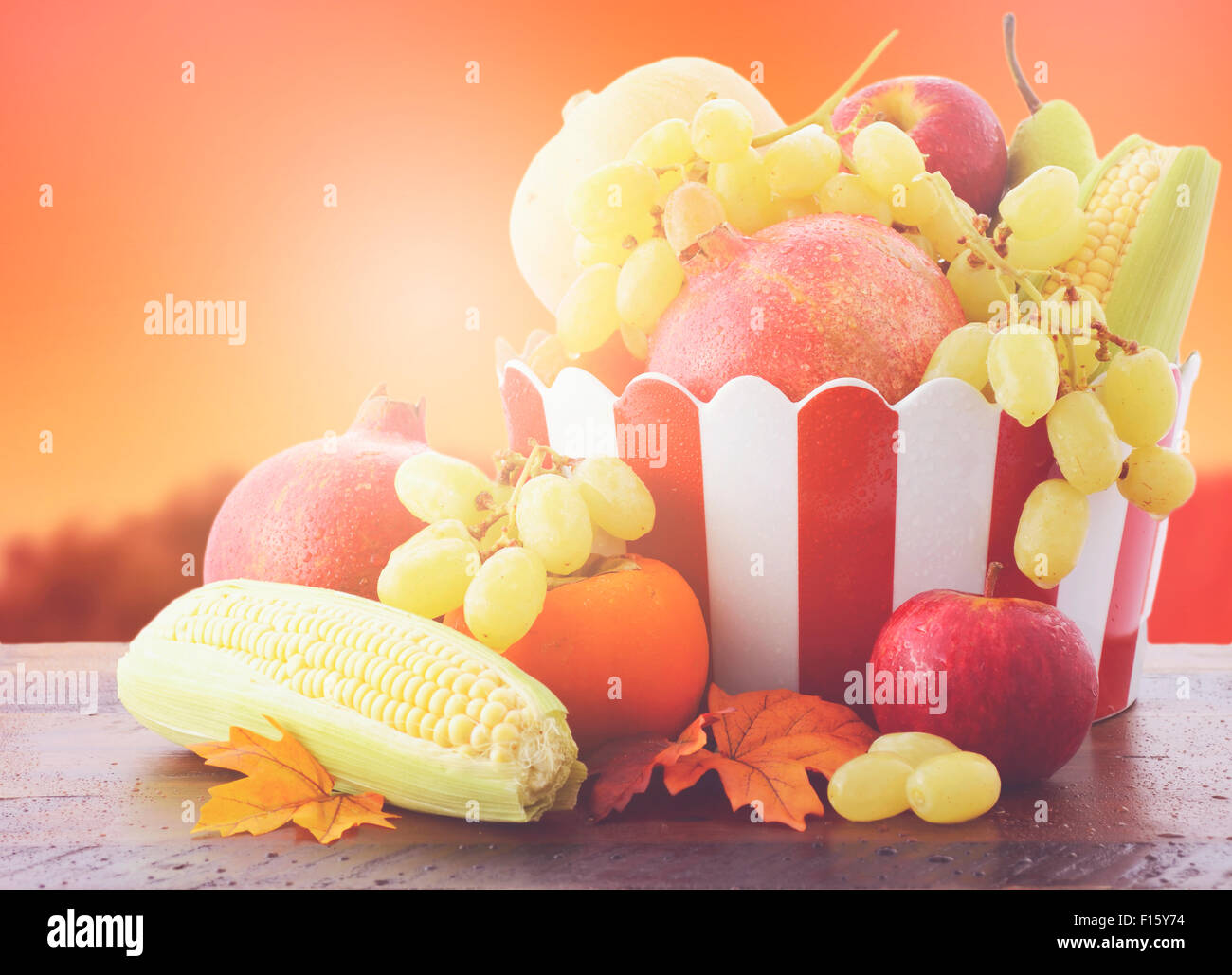 Bowl of Autumn fruit and vegetables on vintage wood table with Autumn ...