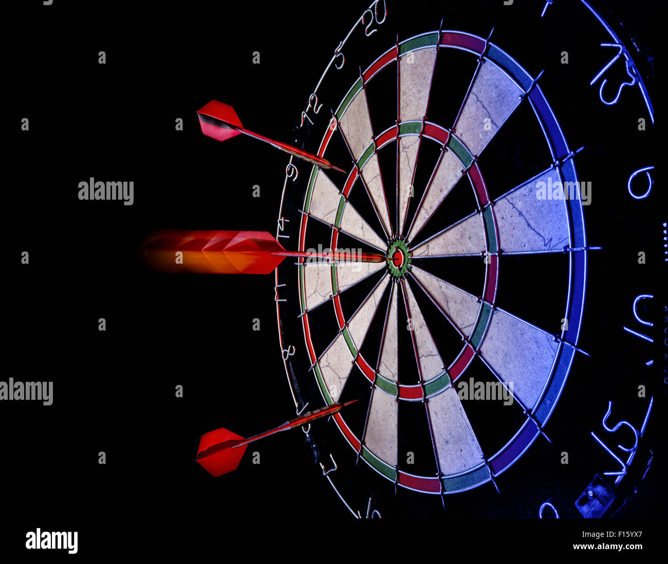 Close-up of a target with three darts Stock Photo - Alamy