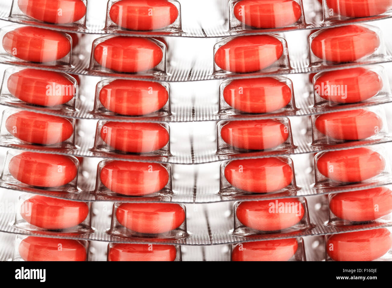 Red tablets in plastic packing as background Stock Photo - Alamy
