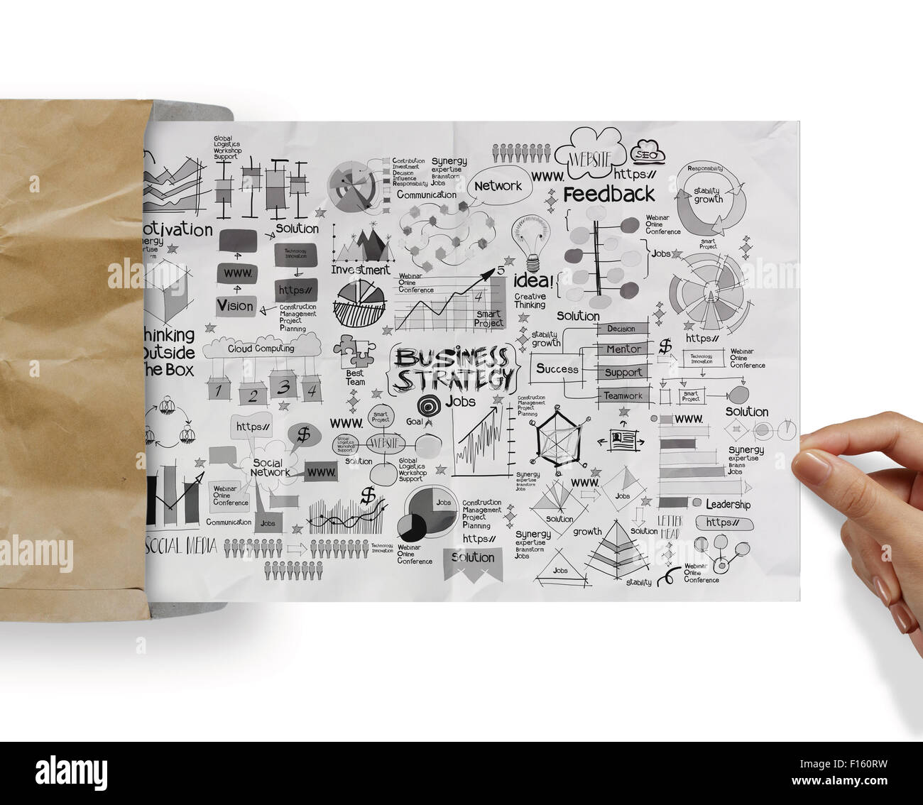 hand pulling hand drawn business strategy on crumpled paper out of ...
