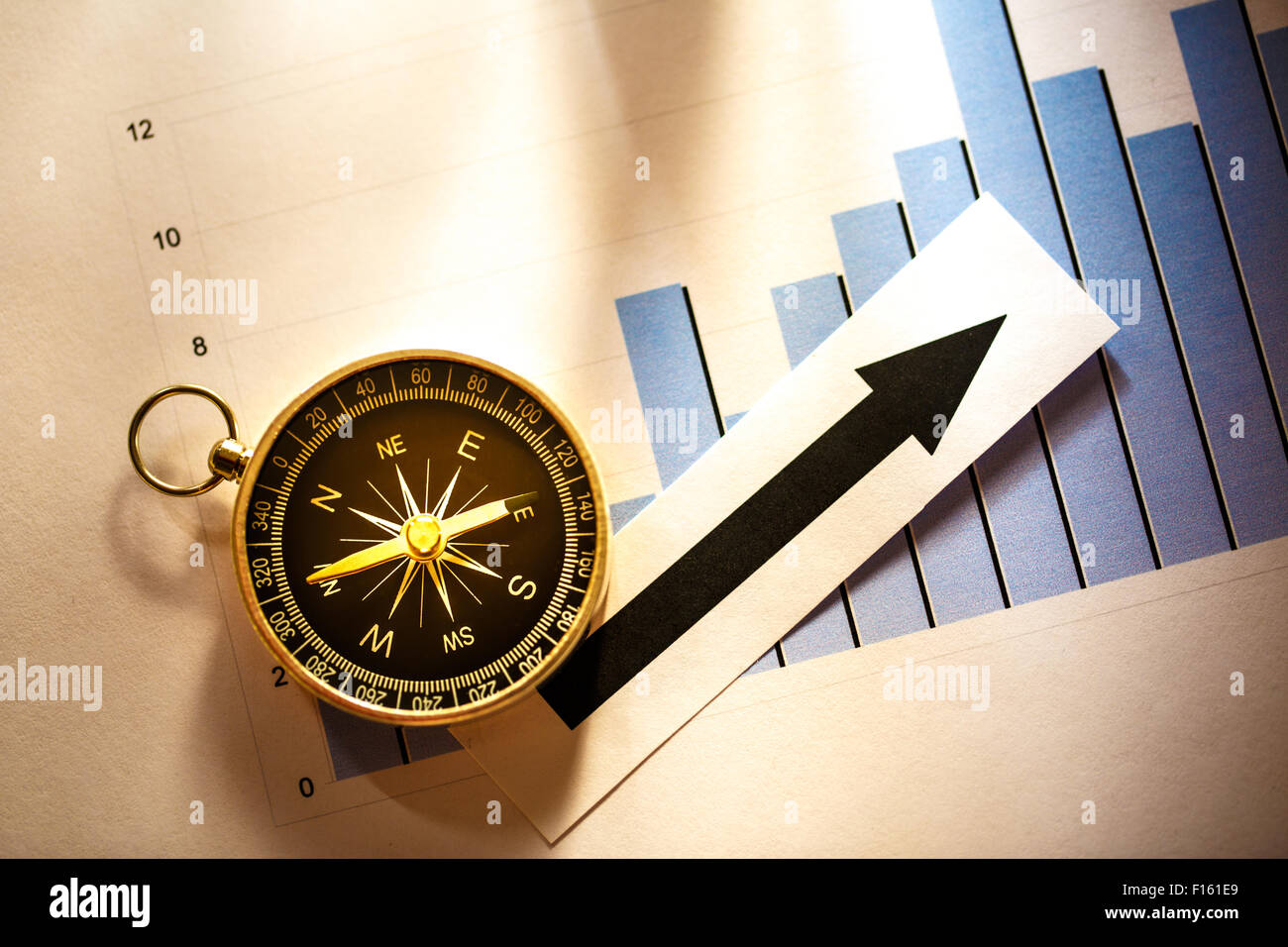 Diagram concept with compass and arrow in light Stock Photo - Alamy