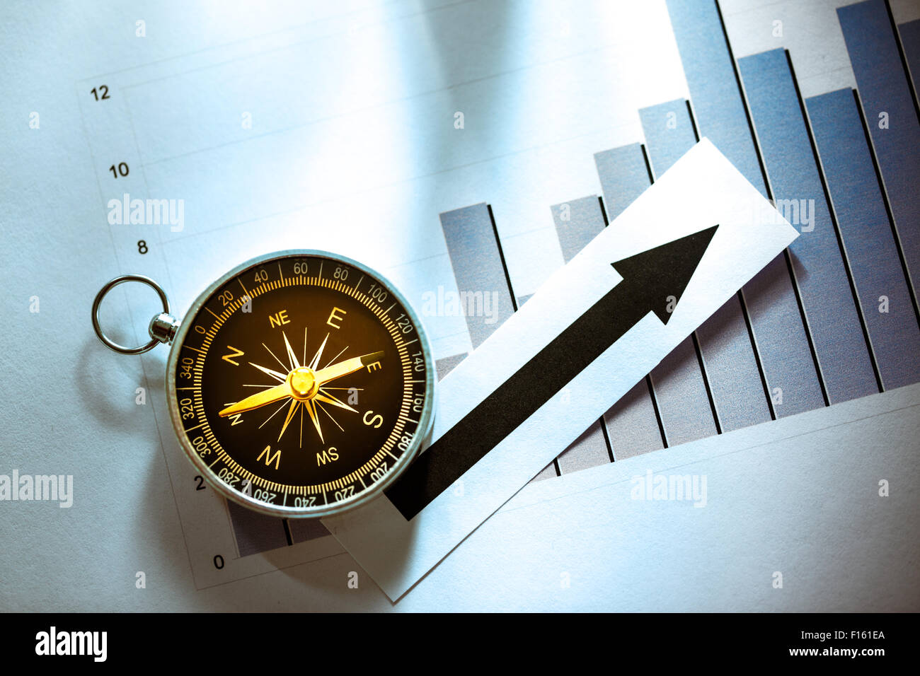 Diagram concept with compass and arrow in light Stock Photo - Alamy