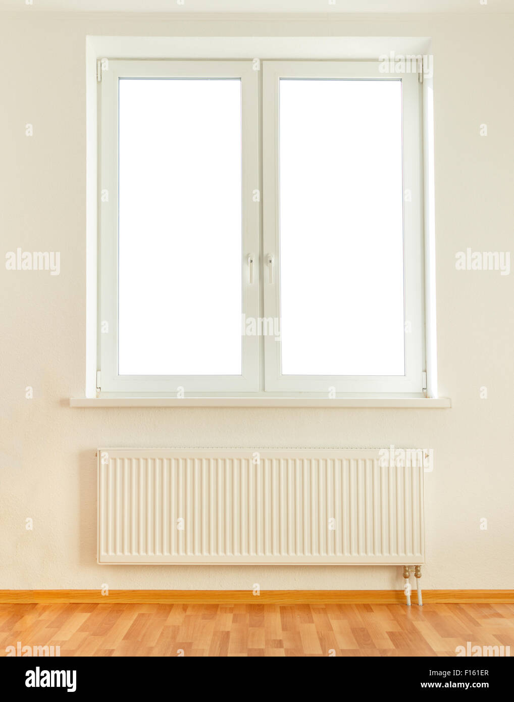 White plastic double window with radiator under it Stock Photo - Alamy