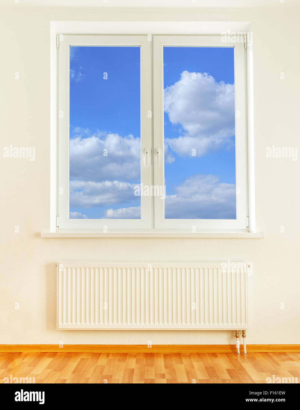 Radiator and window in home interior with blue sky view Stock Photo - Alamy