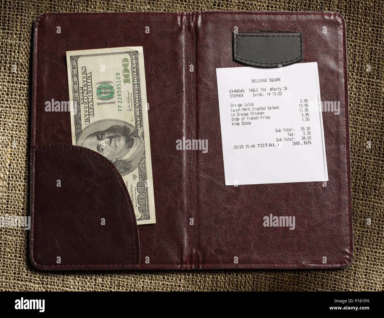 Open check folder with bill and money Stock Photo - Alamy