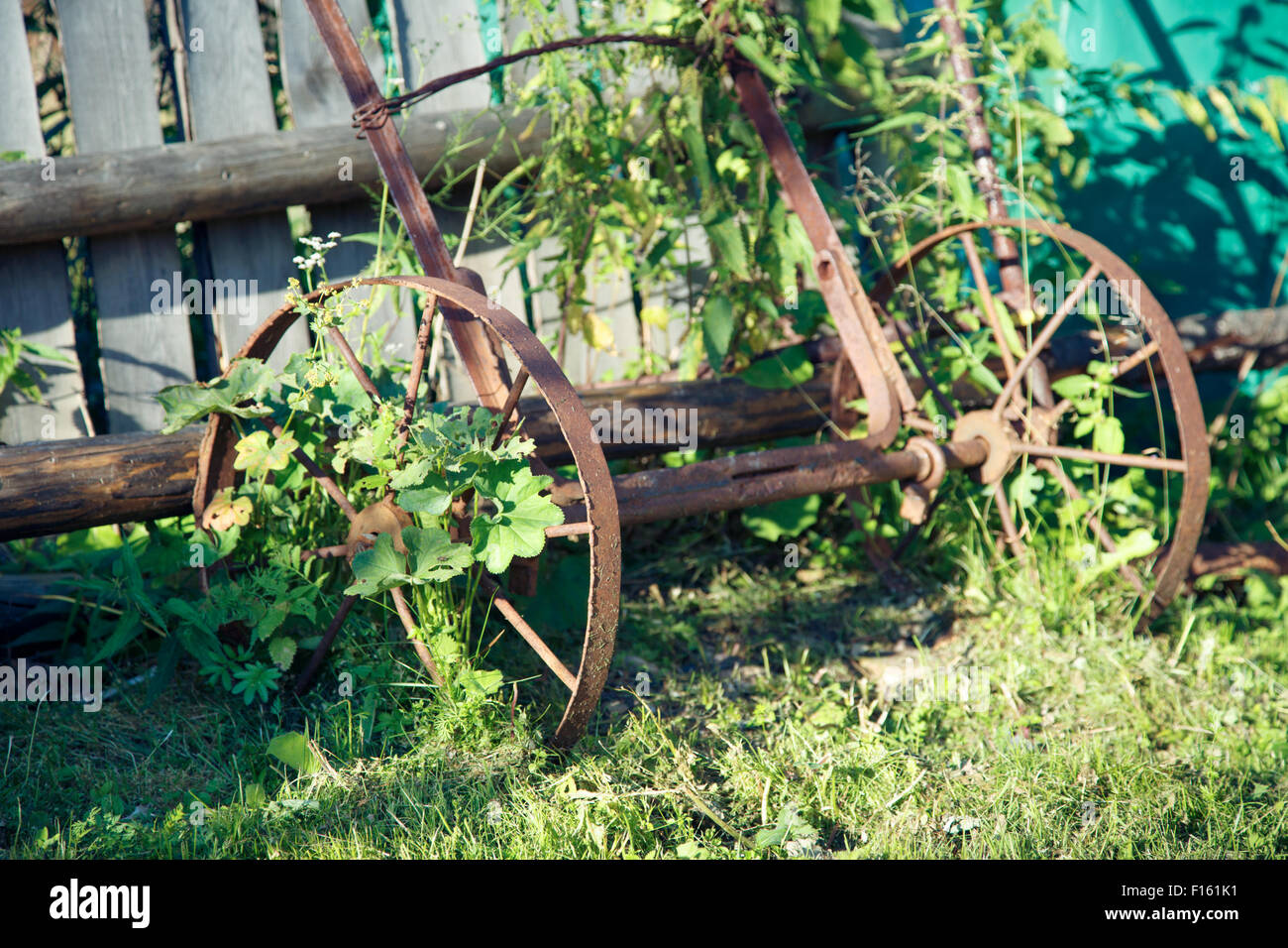 Old wheels from broken cart construction Stock Photo - Alamy