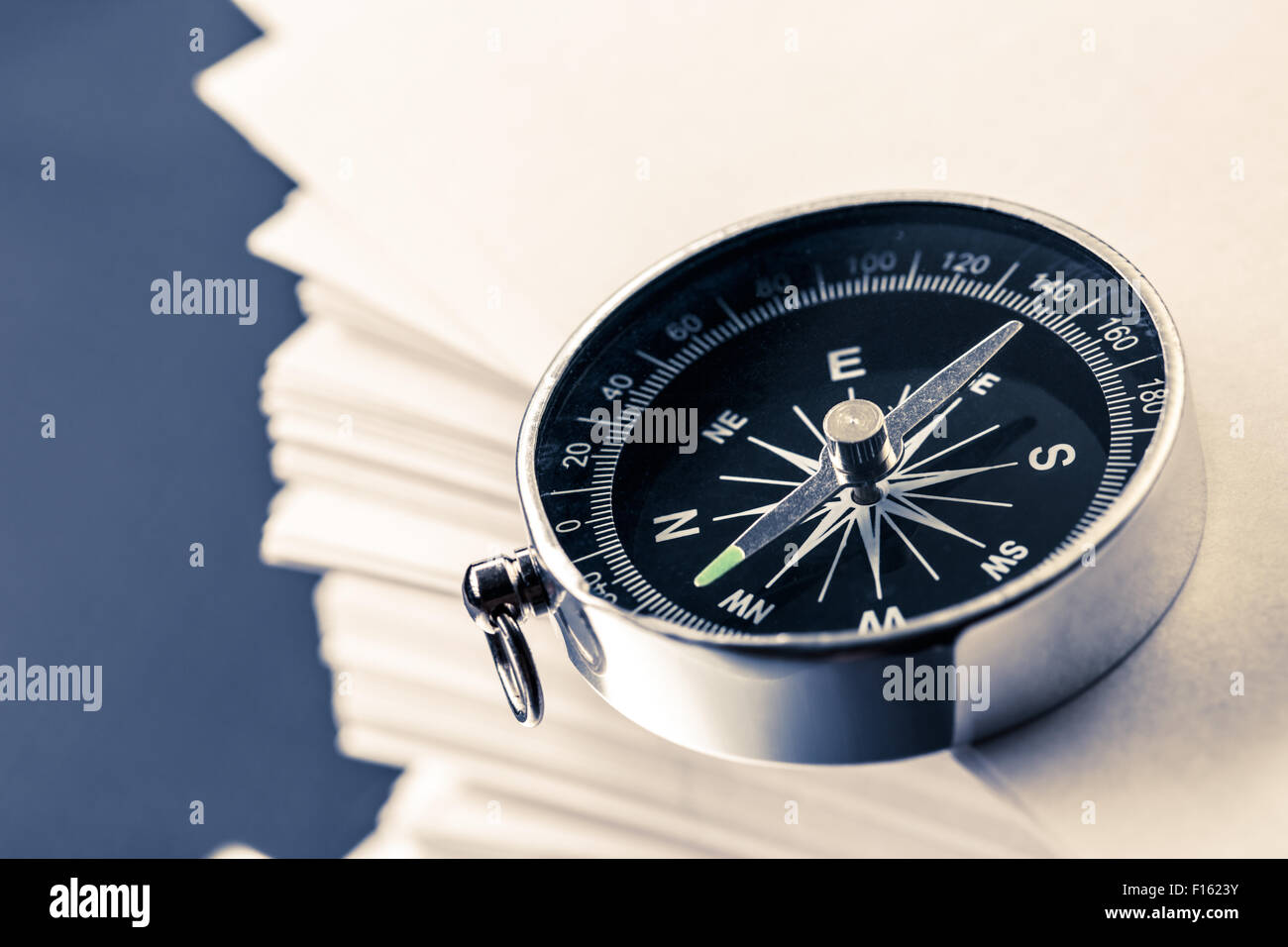 Stack of white cards and compass closeup Stock Photo - Alamy