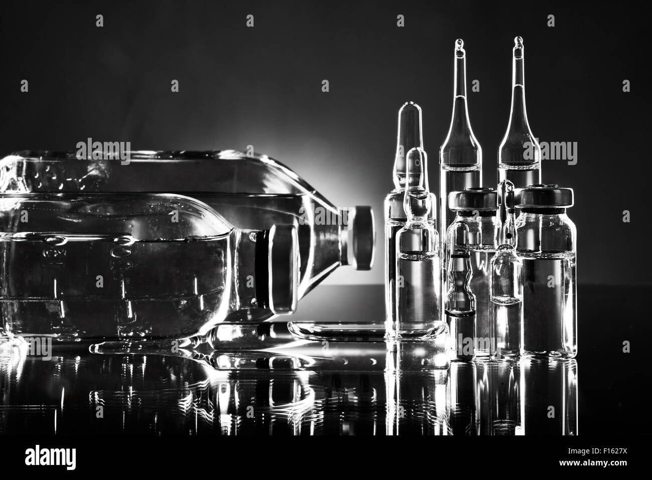 group object of liquid medicinal agent in limpid glassware, black-and ...