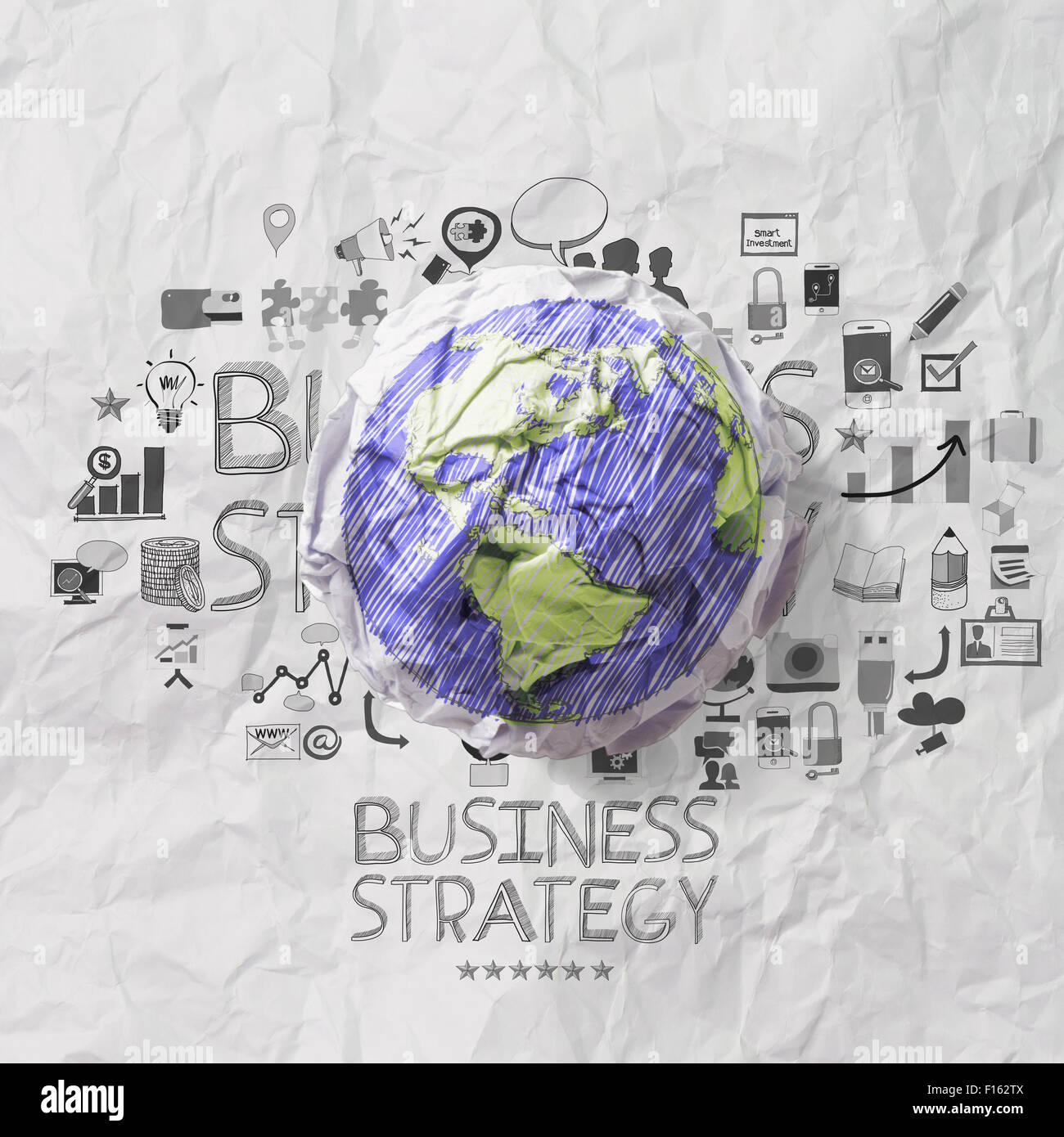 crumpled world and hand drawn business straegy on crumpled paper ...