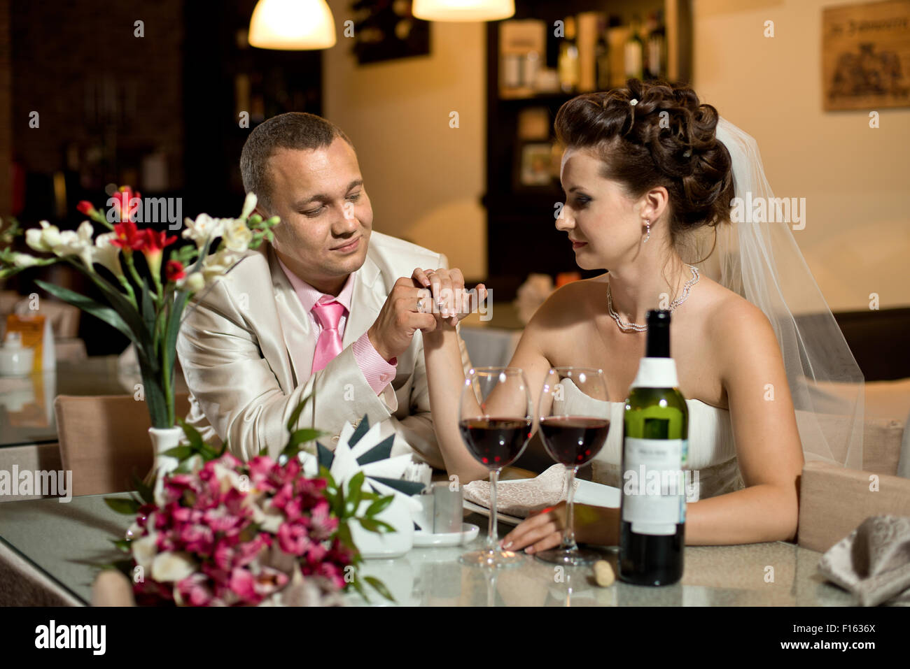 newly married couple sit at table in restaurant, romance wedding dinner ...