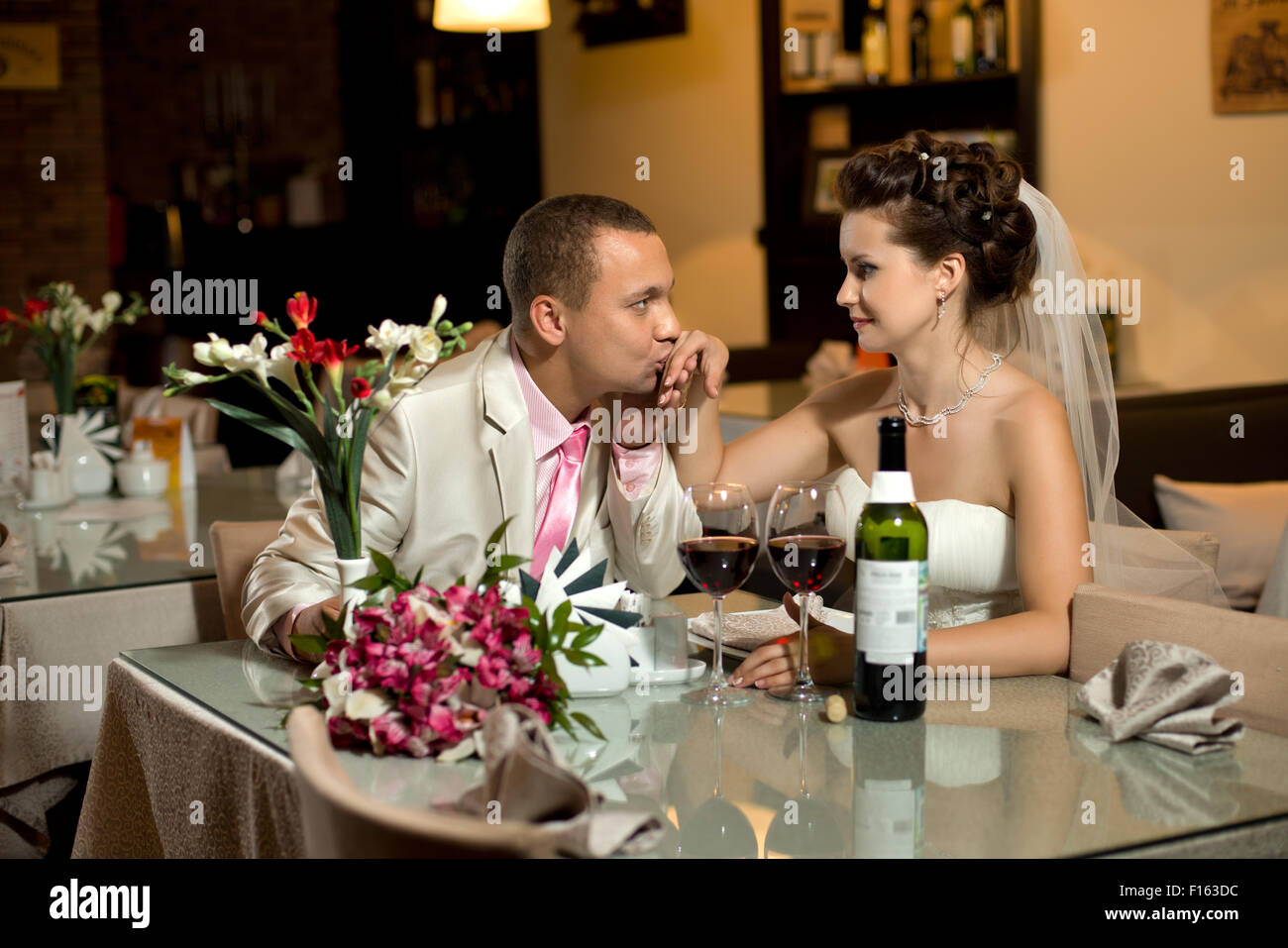newly married couple sit at table in restaurant, romance wedding dinner ...