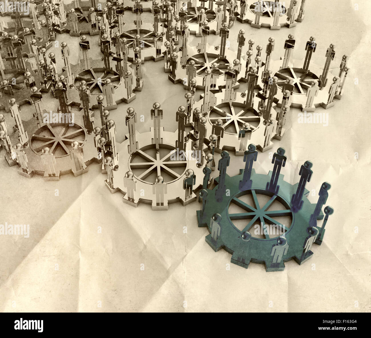 Model of 3d figures on connected cogs as leadership concept on crumpled ...