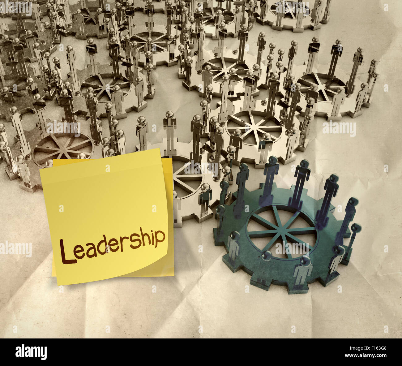 sticky note with 3d figures on connected cogs as leadership concept on ...
