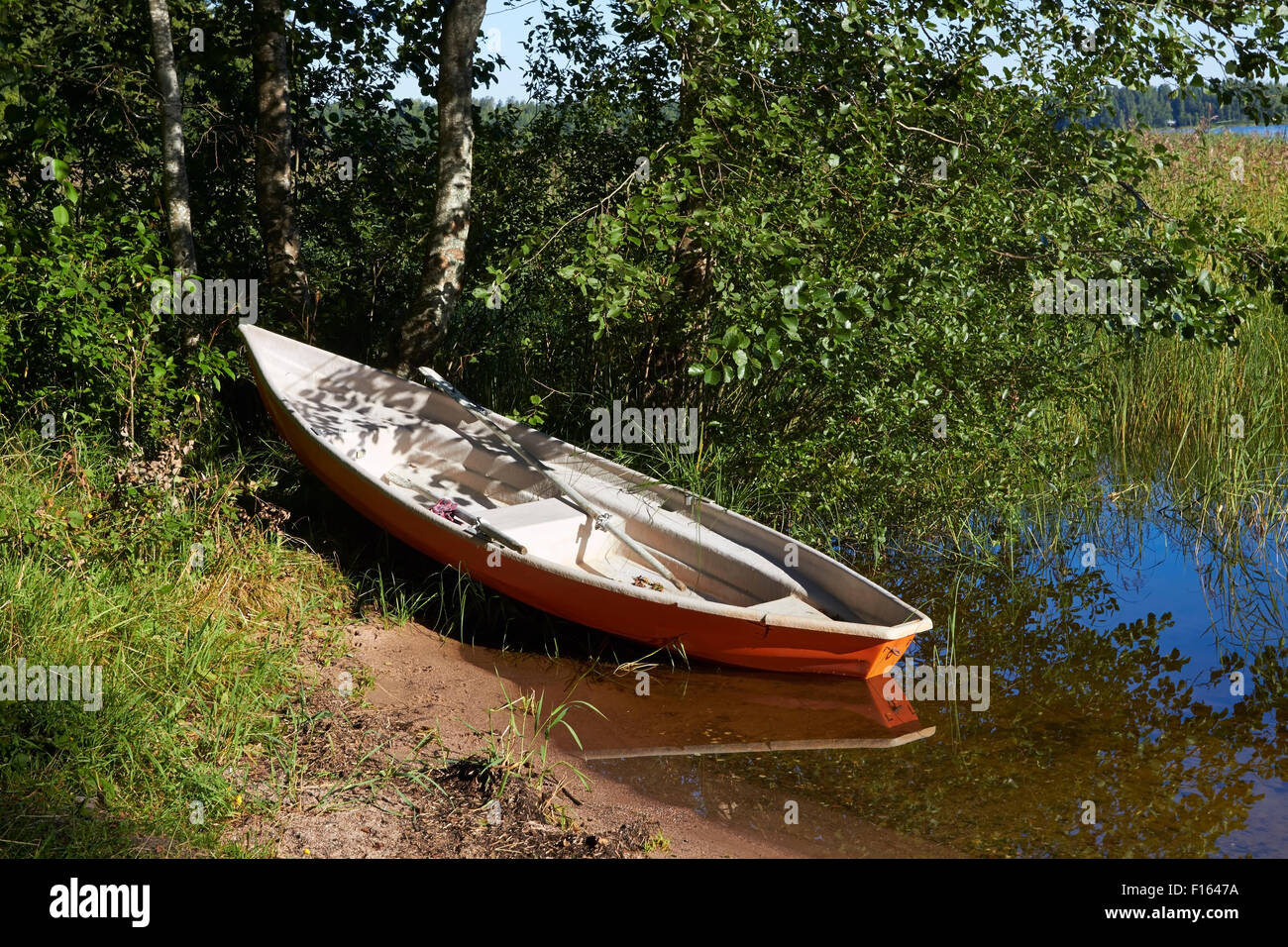 stranded row boat, Finland Stock Photo - Alamy