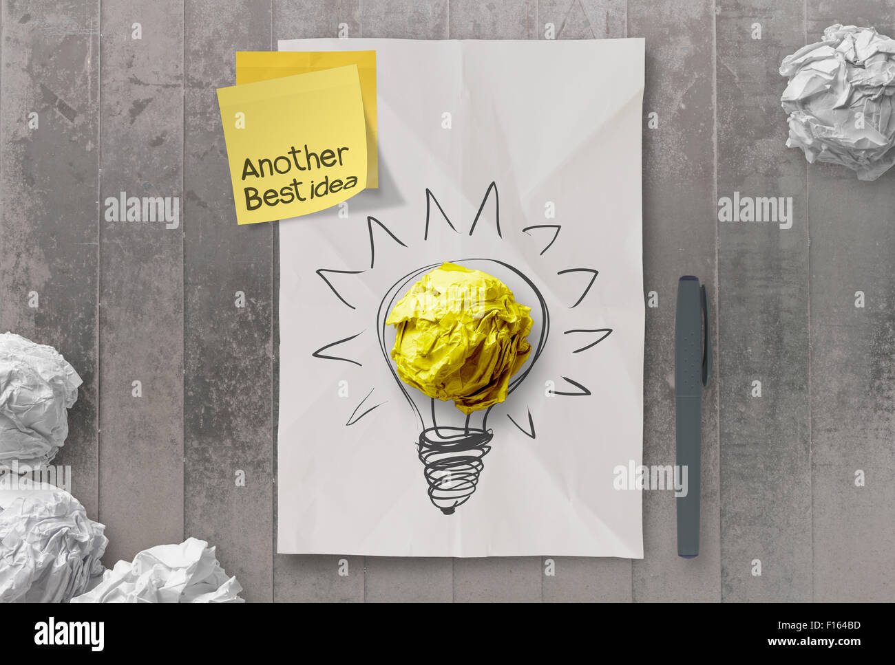 sticky note with another idea light bulb on crumpled paper as creative ...